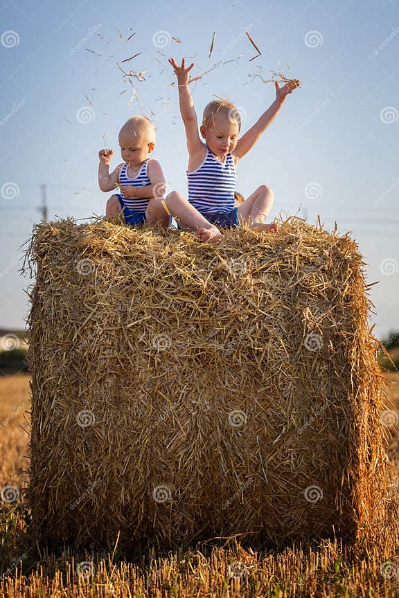 Children Play Sitting on a Haystack Stock Image - Image of play, hands ...