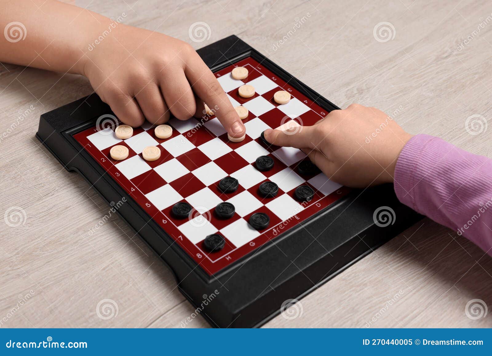 Children Playing Checkers at Light Wooden Table, Closeup Stock Image ...