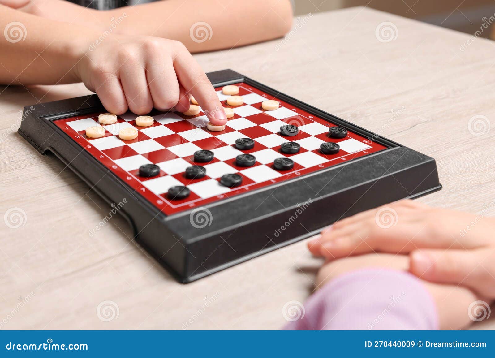 Children Playing Checkers at Light Wooden Table, Closeup Stock Image ...