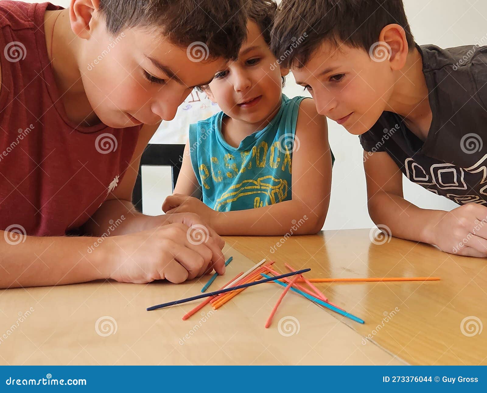 Children Playing with Colored Sticks on the Table at Home Stock Photo ...