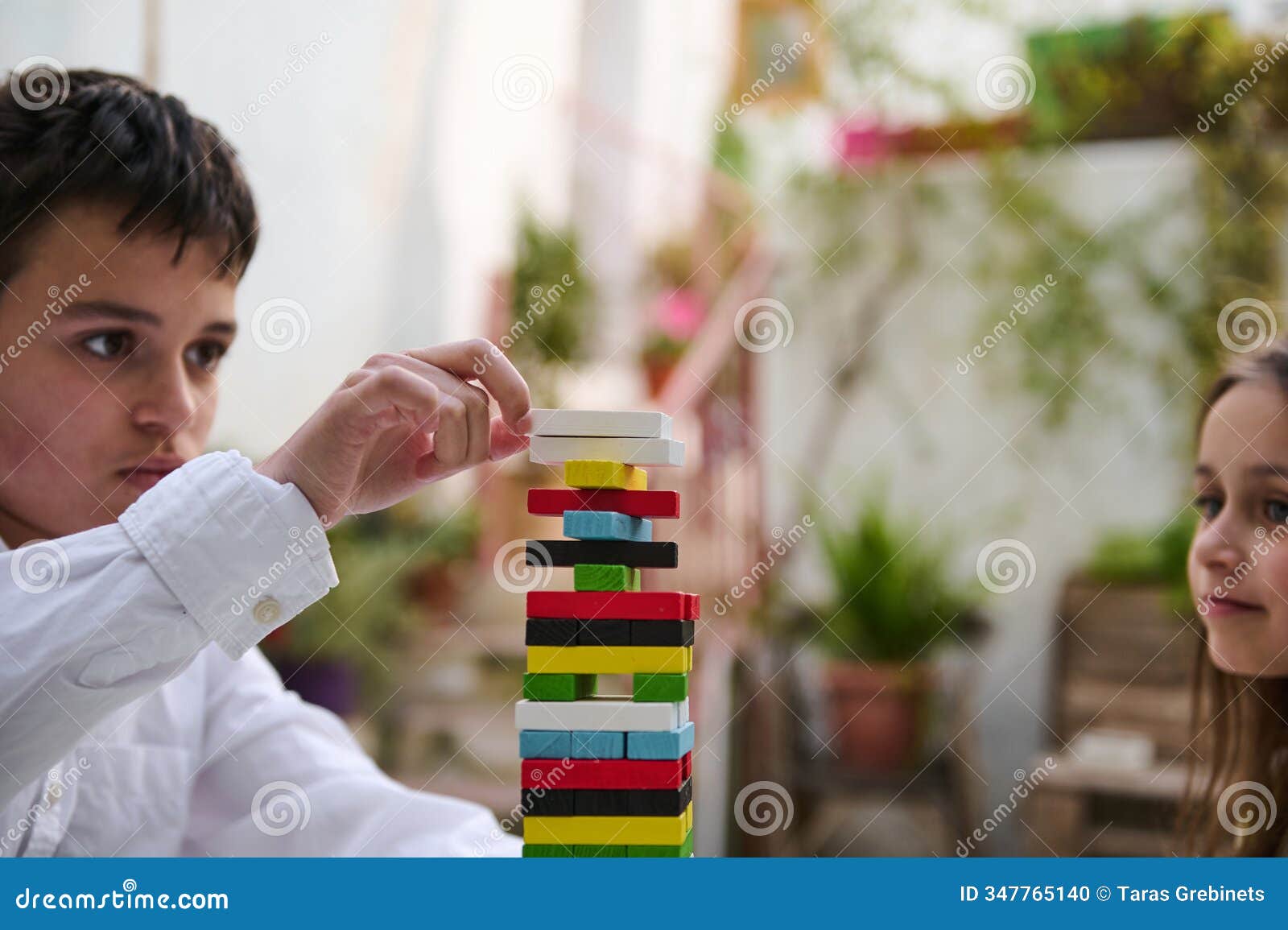 Children Playing with Colorful Blocks in an Outdoor Garden Setting ...