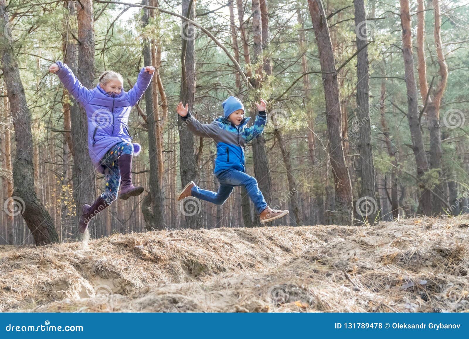 Children jump over the pit stock photo. Image of game - 131789478