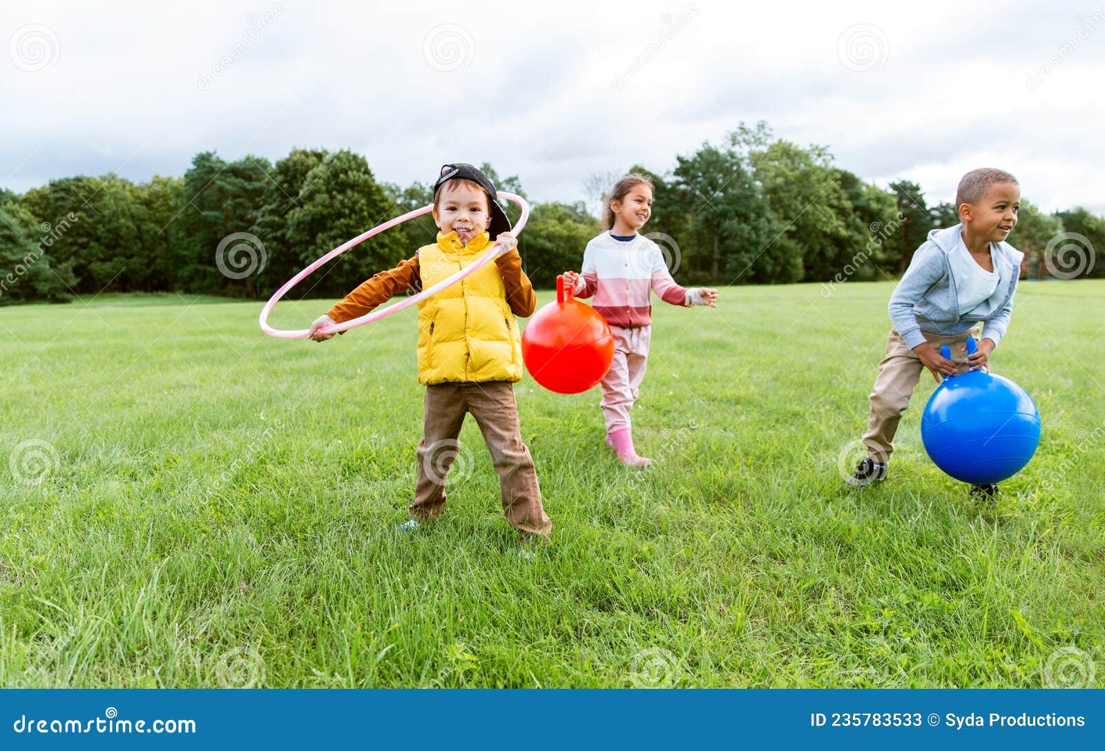 Children Playing with Hoppers and Hoop at Park Stock Image - Image of ...