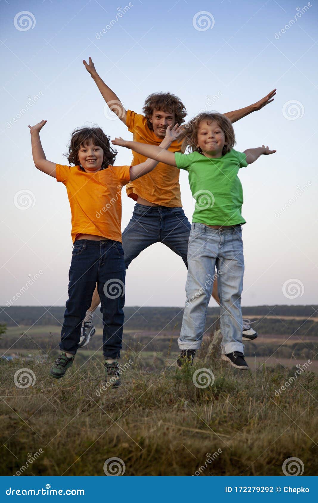 Children Playing Jumping on Summer Sunset Meadow Silhouetted Stock ...