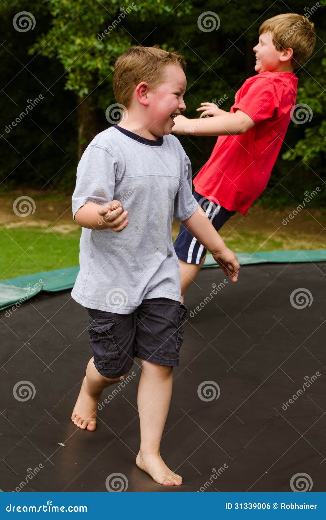 Children Playing while Jumping on Trampoline Outdoors Stock Photo ...