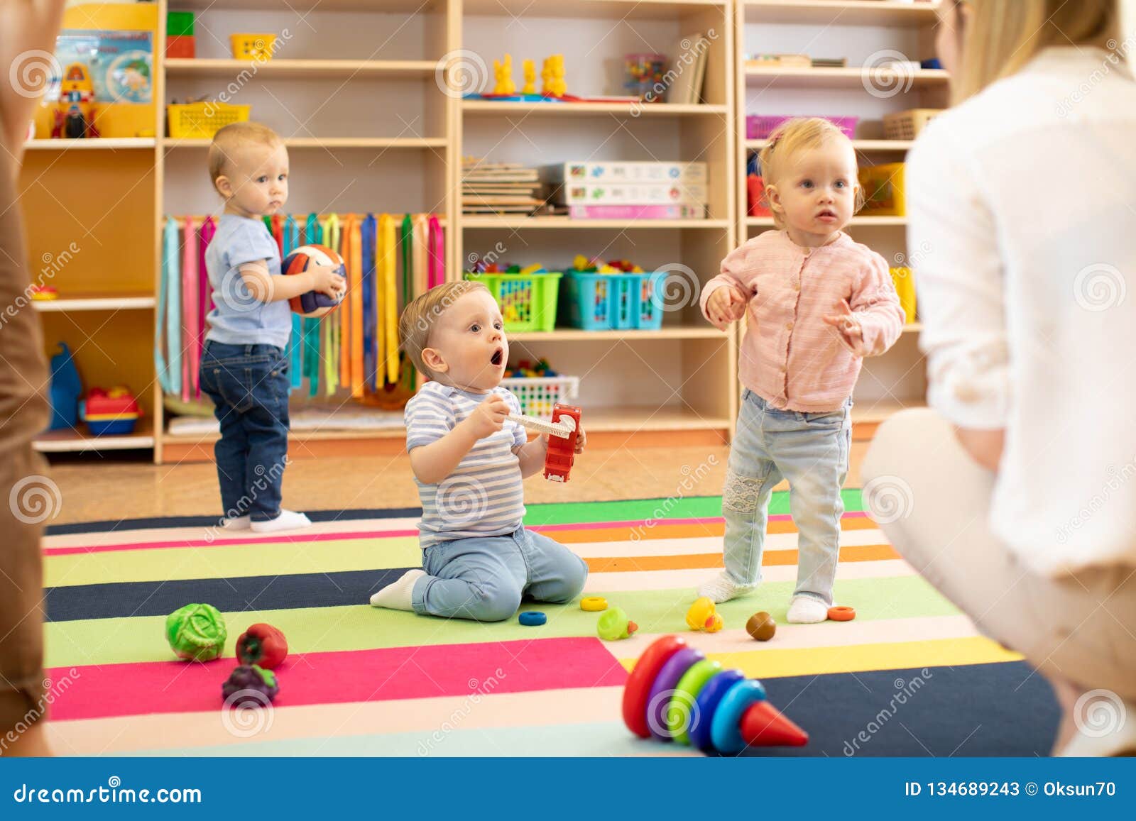 Children Playing in Kindergarten with a Teacher Stock Image - Image of ...
