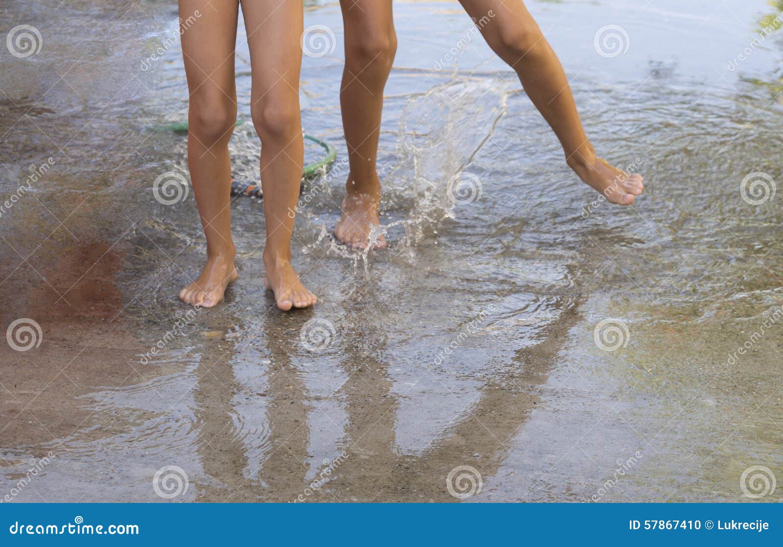 Children Playing in the Puddle Stock Photo - Image of legs, water: 57867410