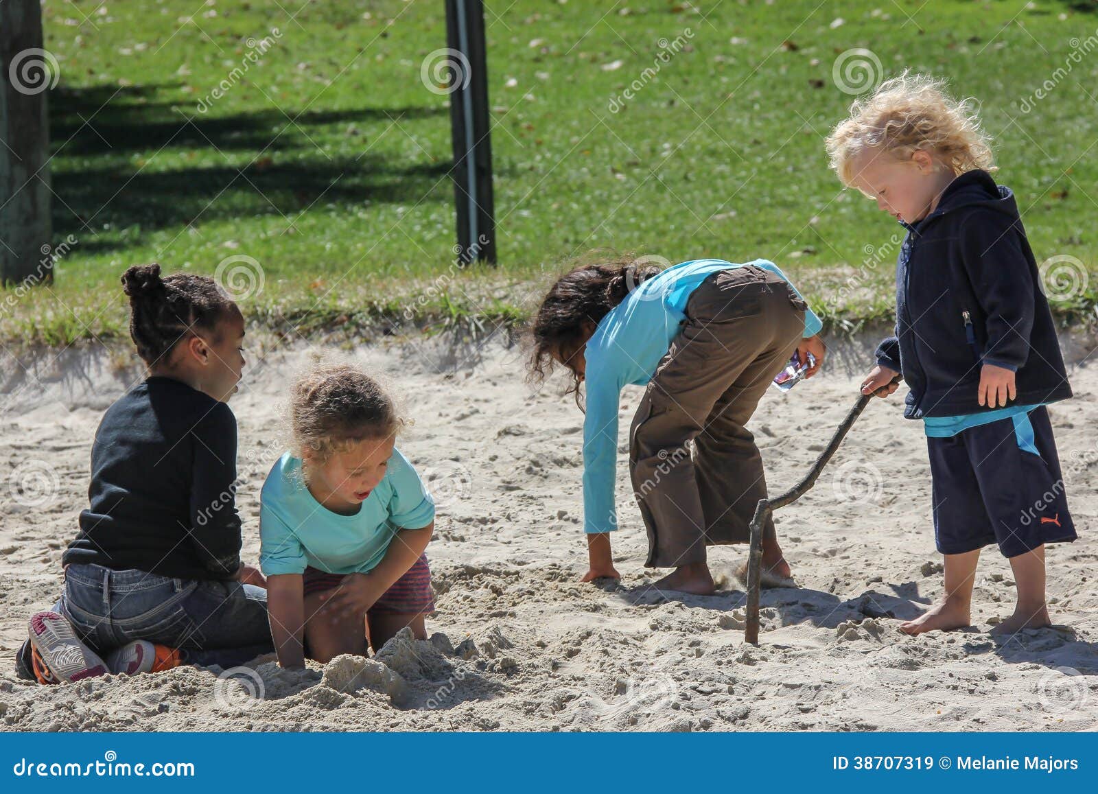 Children Digging On A Cloudy Welsh Beach. Editorial Photo ...