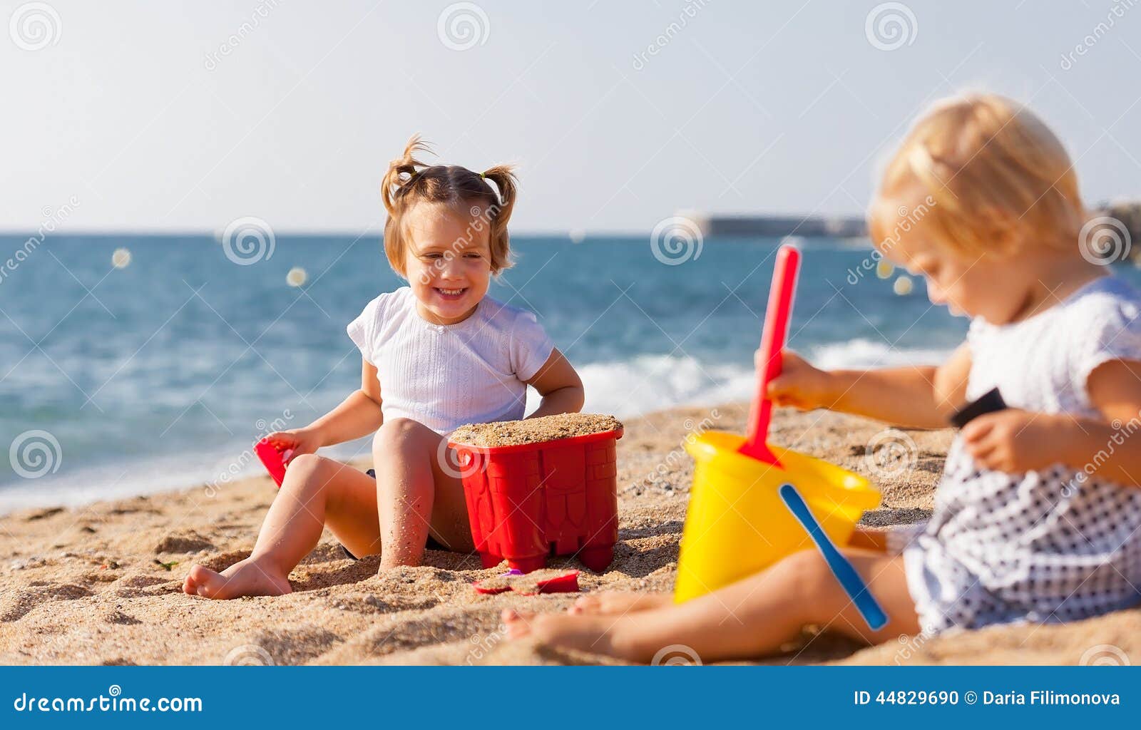 Children playing with sand stock photo. Image of beach - 44829690