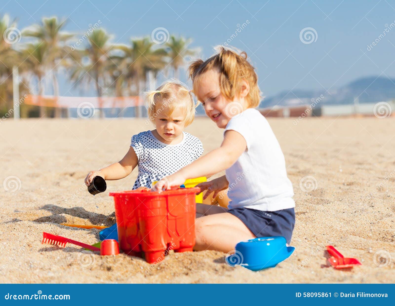 Children playing with sand stock image. Image of vacation - 58095861
