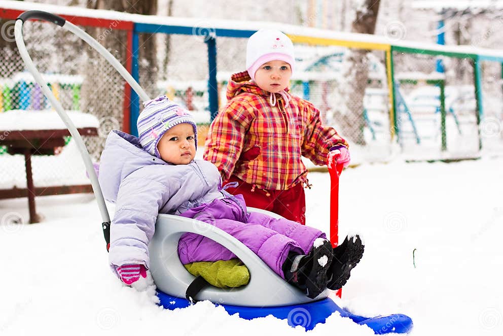 Children Playing with Sled and Spade in Snow Stock Photo - Image of ...
