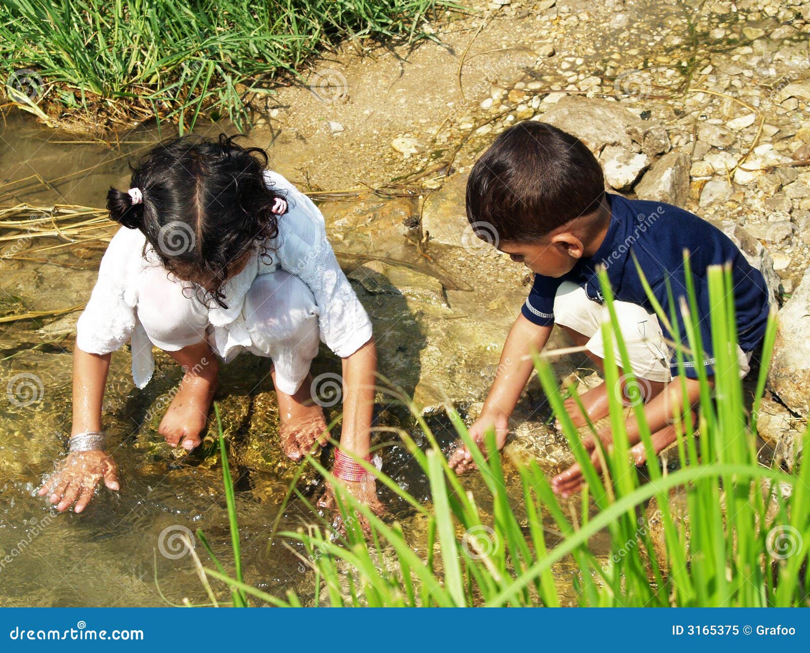 Children playing in stream stock image. Image of outside - 3165375