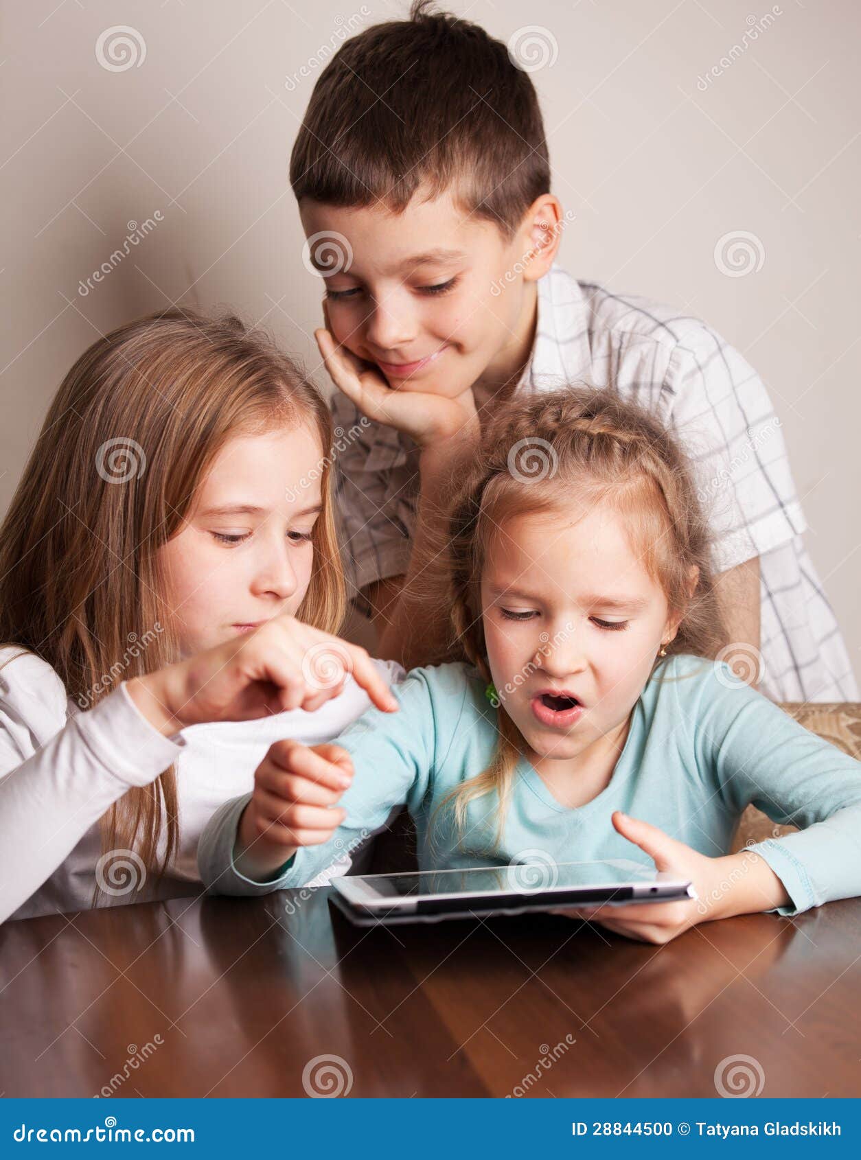 Children playing on tablet stock photo. Image of home - 28844500
