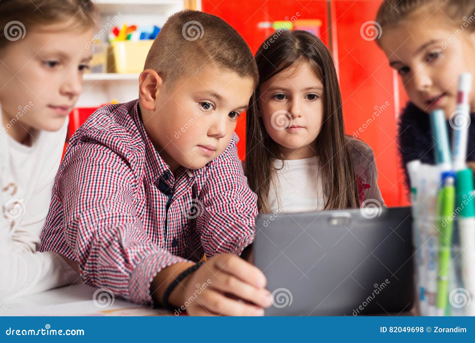 Children playing on tablet stock photo. Image of hand - 82049698