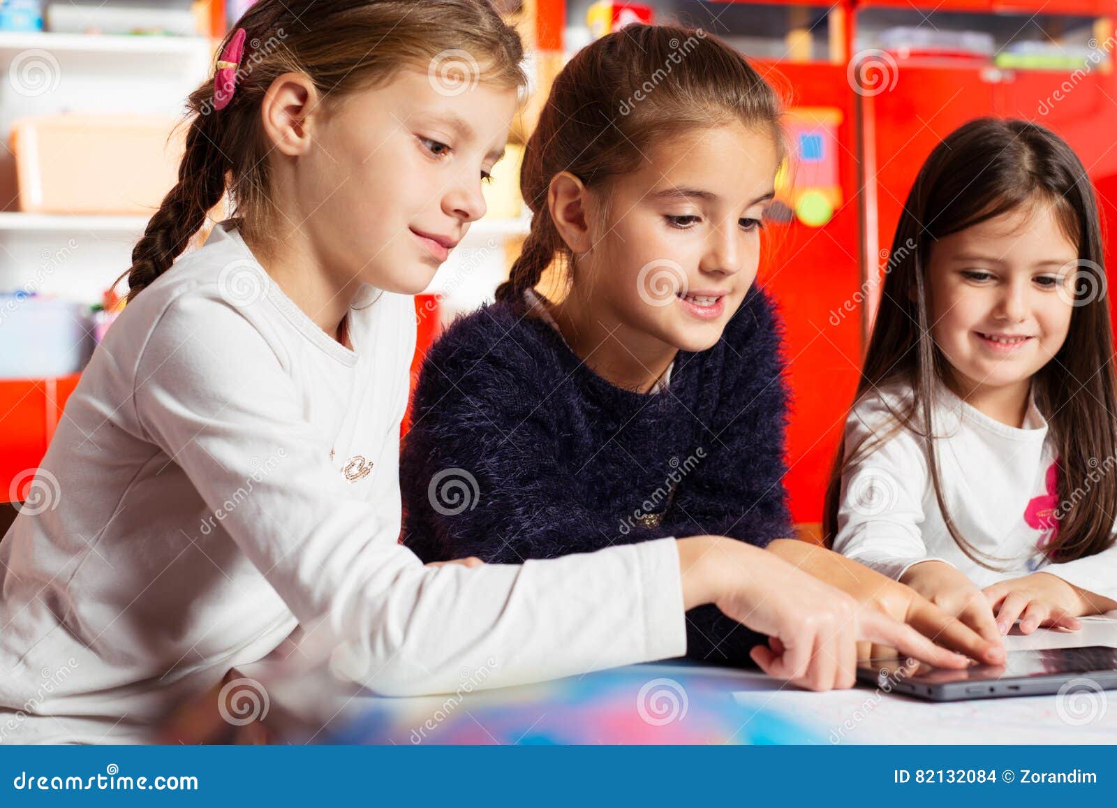 Children playing on tablet stock photo. Image of female - 82132084