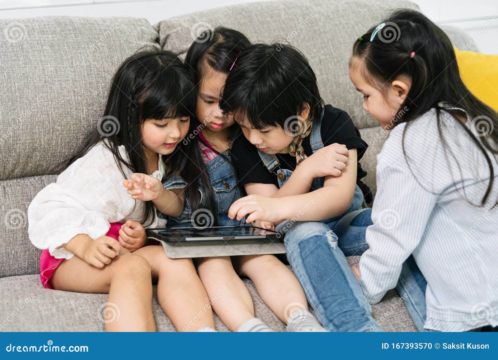 Children Playing on Tablet. Group of Kids Playing with Laptop Together ...
