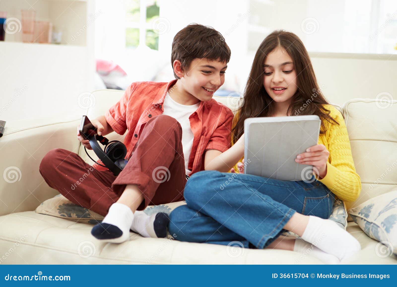 Children Playing with Tablet and MP3 Player Stock Photo - Image of sofa ...