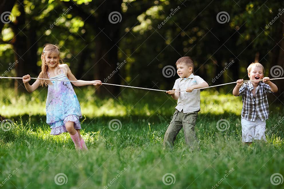 Children Pulling the Rope Outdoors Stock Image - Image of activity ...