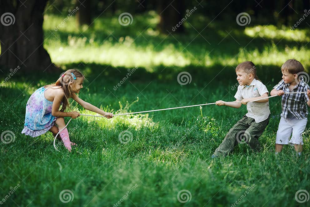 Children Pulling the Rope Outdoors Stock Photo - Image of kids, park ...