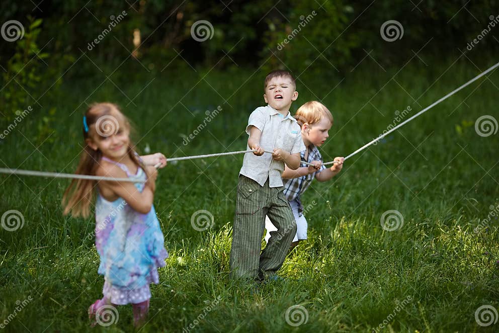 Children Pulling the Rope Outdoors Stock Image - Image of happy, girl ...