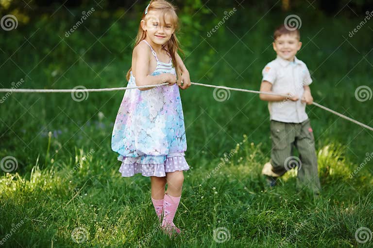 Children Pulling the Rope Outdoors Stock Image - Image of casual, happy ...