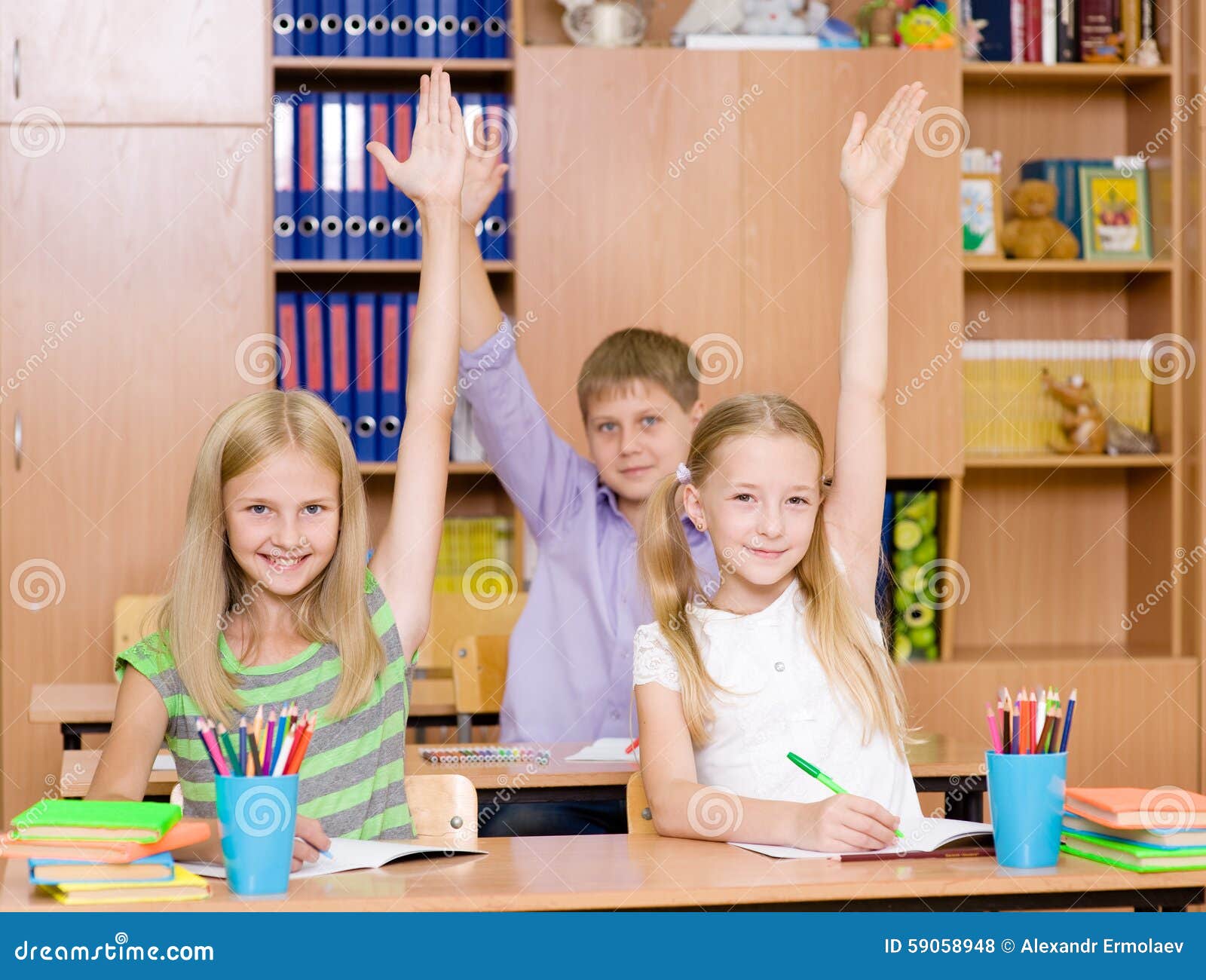 Children Raising Hands Knowing the Answer To the Question Stock Photo ...