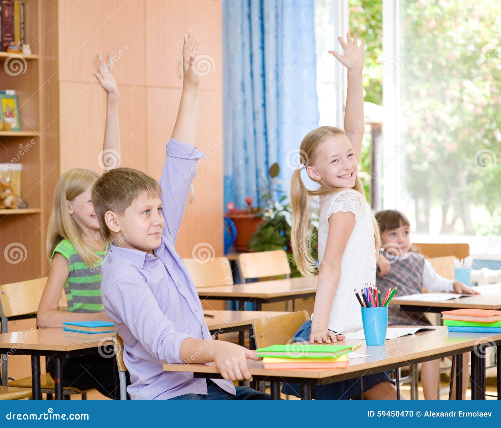 Children Raising Hands Knowing the Answer To the Question Stock Photo ...