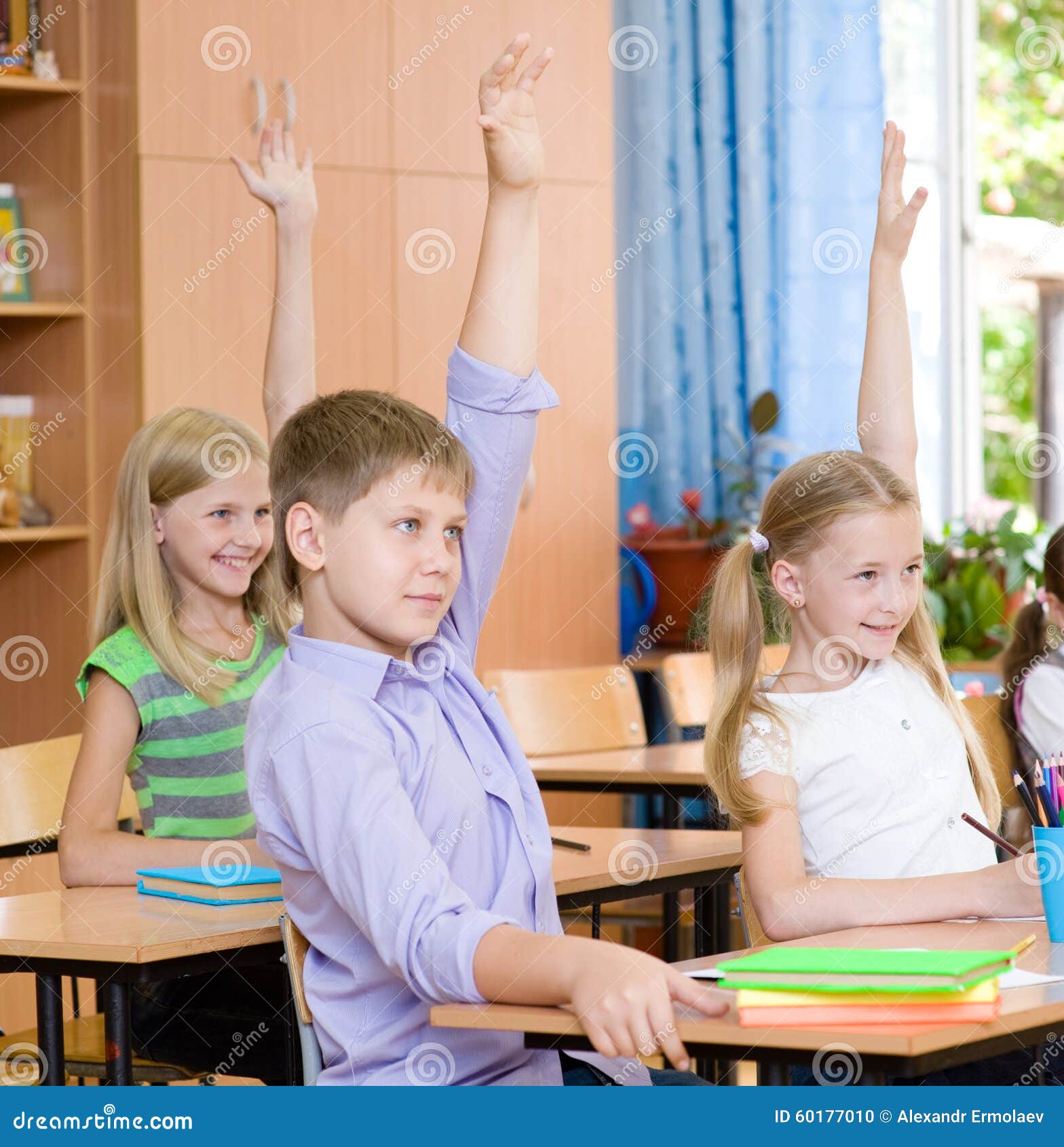 Children Raising Hands Knowing the Answer To the Question Stock Photo ...
