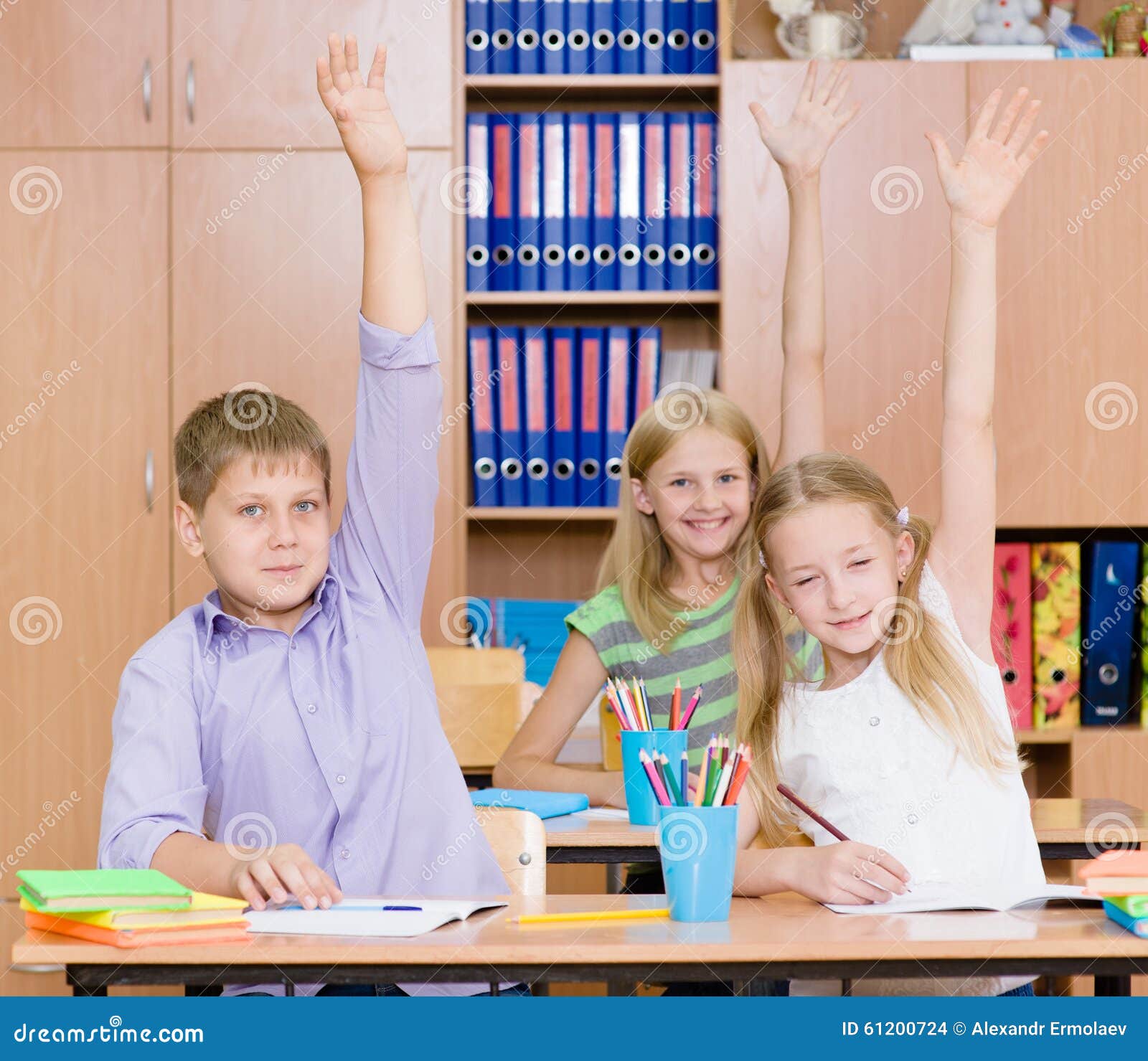 Children Raising Hands Knowing the Answer To the Question Stock Photo ...