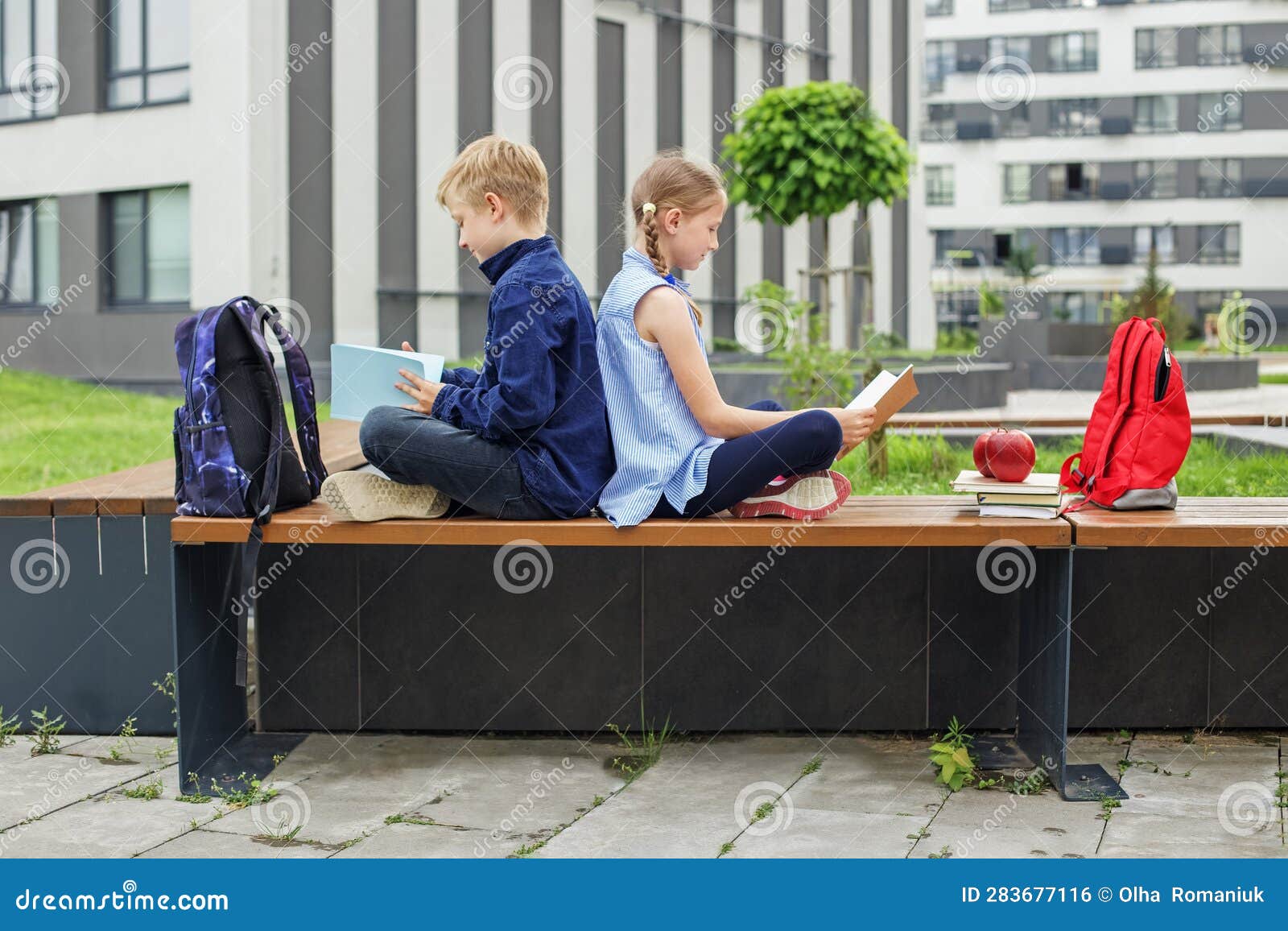 Children Read Books Sitting on Bench in School Yard. Back To School ...