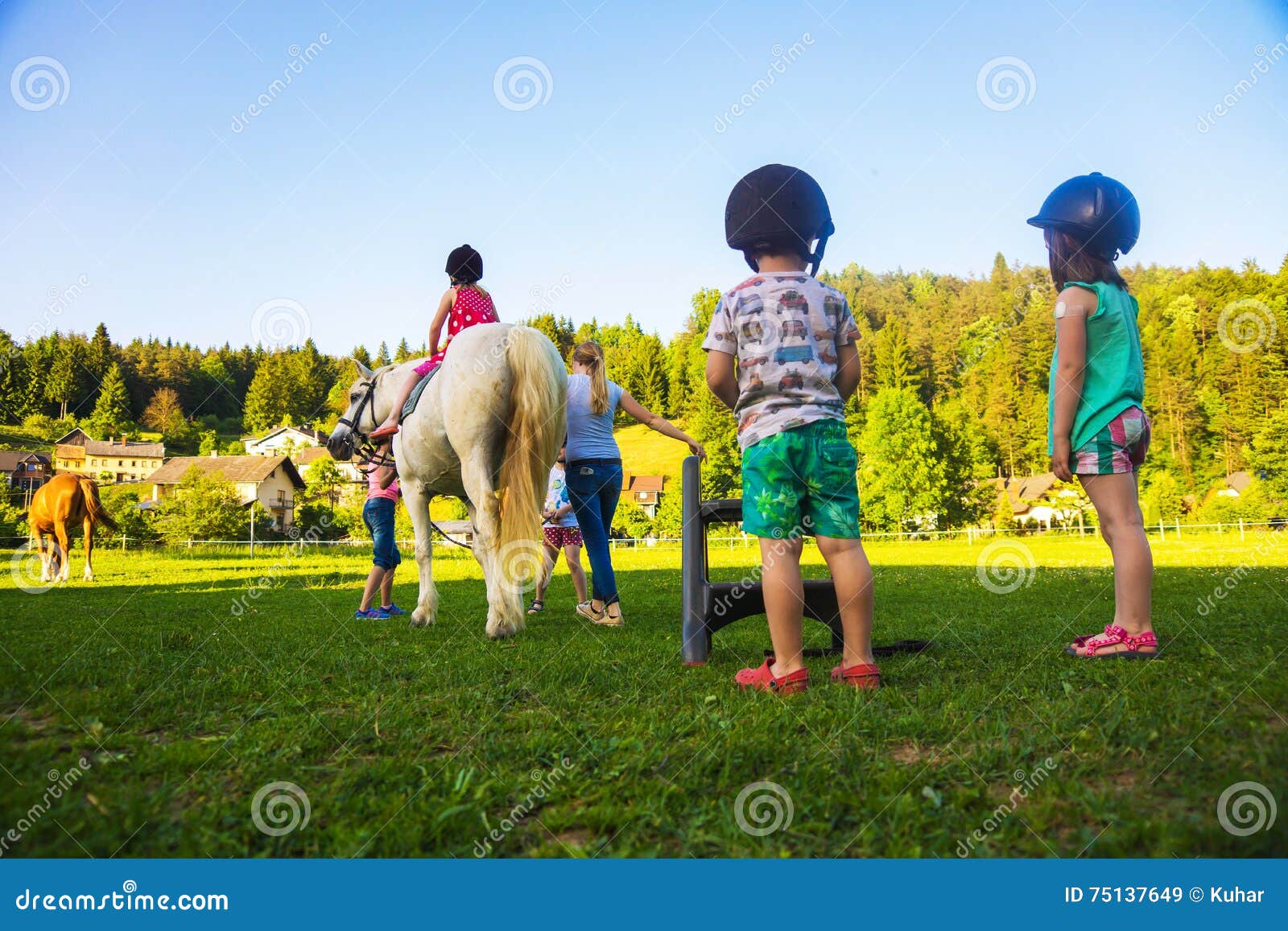 Children riding horse editorial stock image. Image of helmet - 75137649