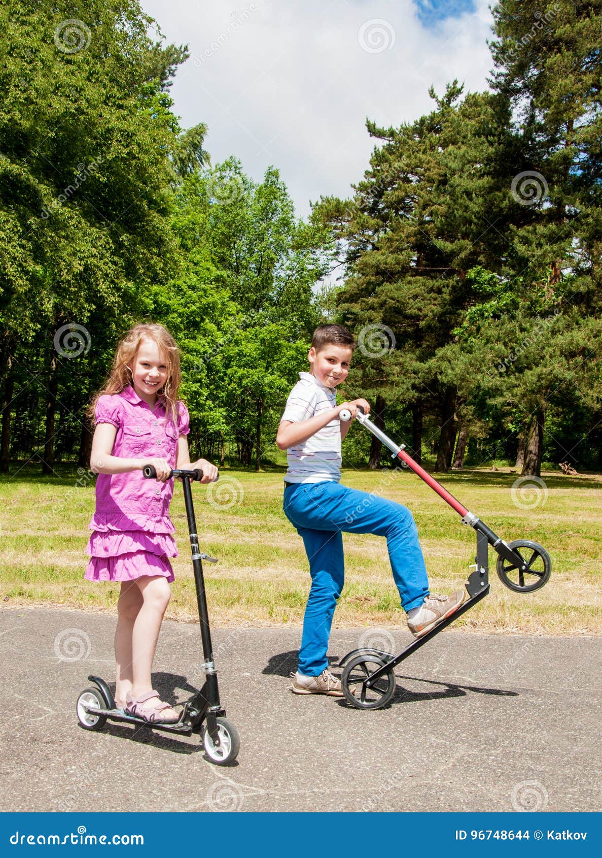 Children Riding Scooters in a Park Stock Photo - Image of lifestyle ...
