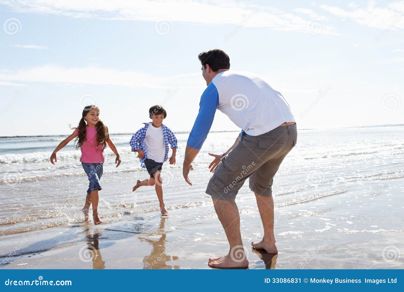 Children Running Towards Father on Beach Stock Image - Image of ...