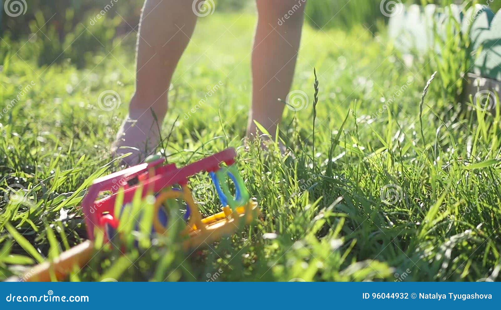 Children`s Bare Feet Running through the Grass. Fun Outdoors Stock ...