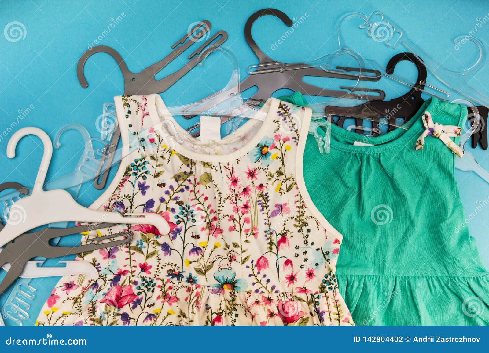 Children`s Clothes with Hangers on a Blue Background Stock Photo ...