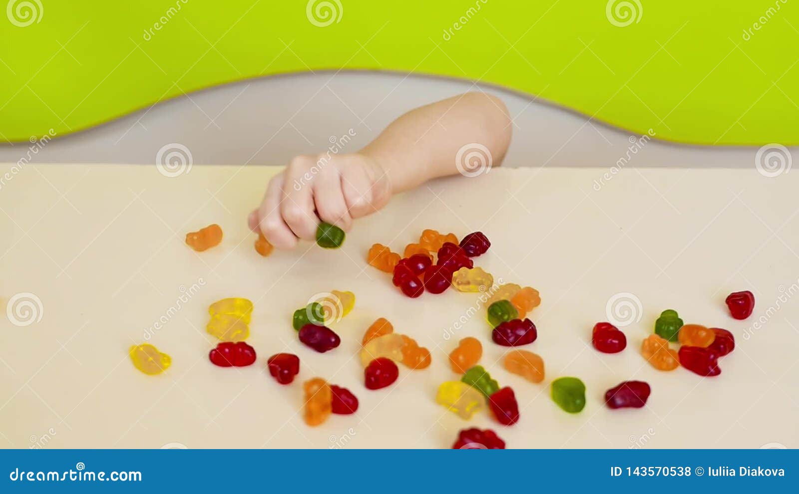 Children`s Hand Appears from Under the Table and Takes Bright Fruit ...