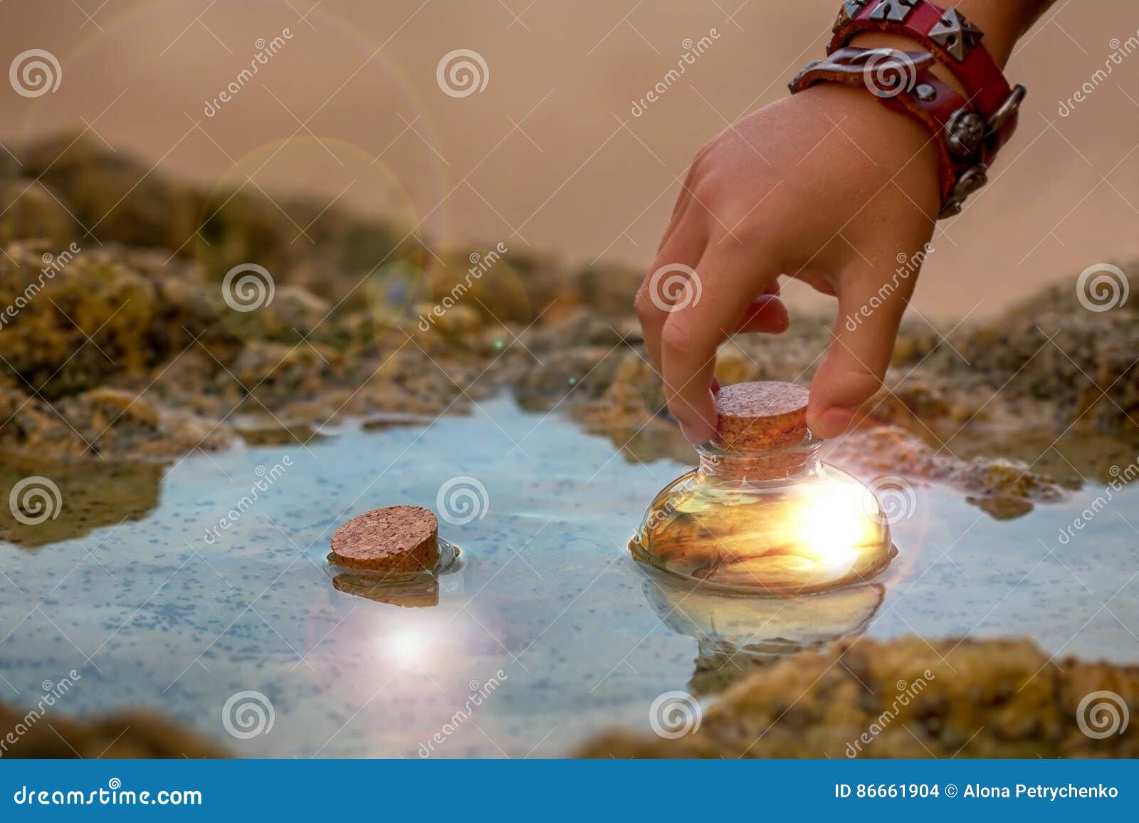 Children`s Hand Pulls from the Pond Glowing Magic Bottle Stock Photo ...