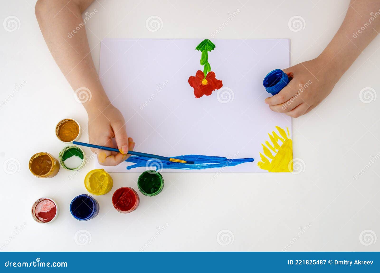 Children S Pens Draw a Drawing of a Flower on a White Background Stock ...