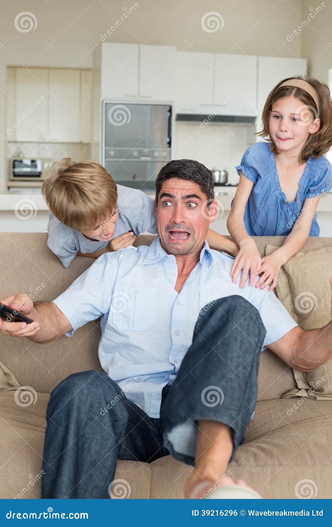 Children Scaring Father Watching Television Stock Photo - Image of male ...