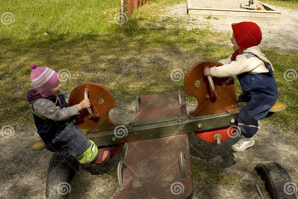 Children on a seesaw stock photo. Image of kids, cooperates - 9414246