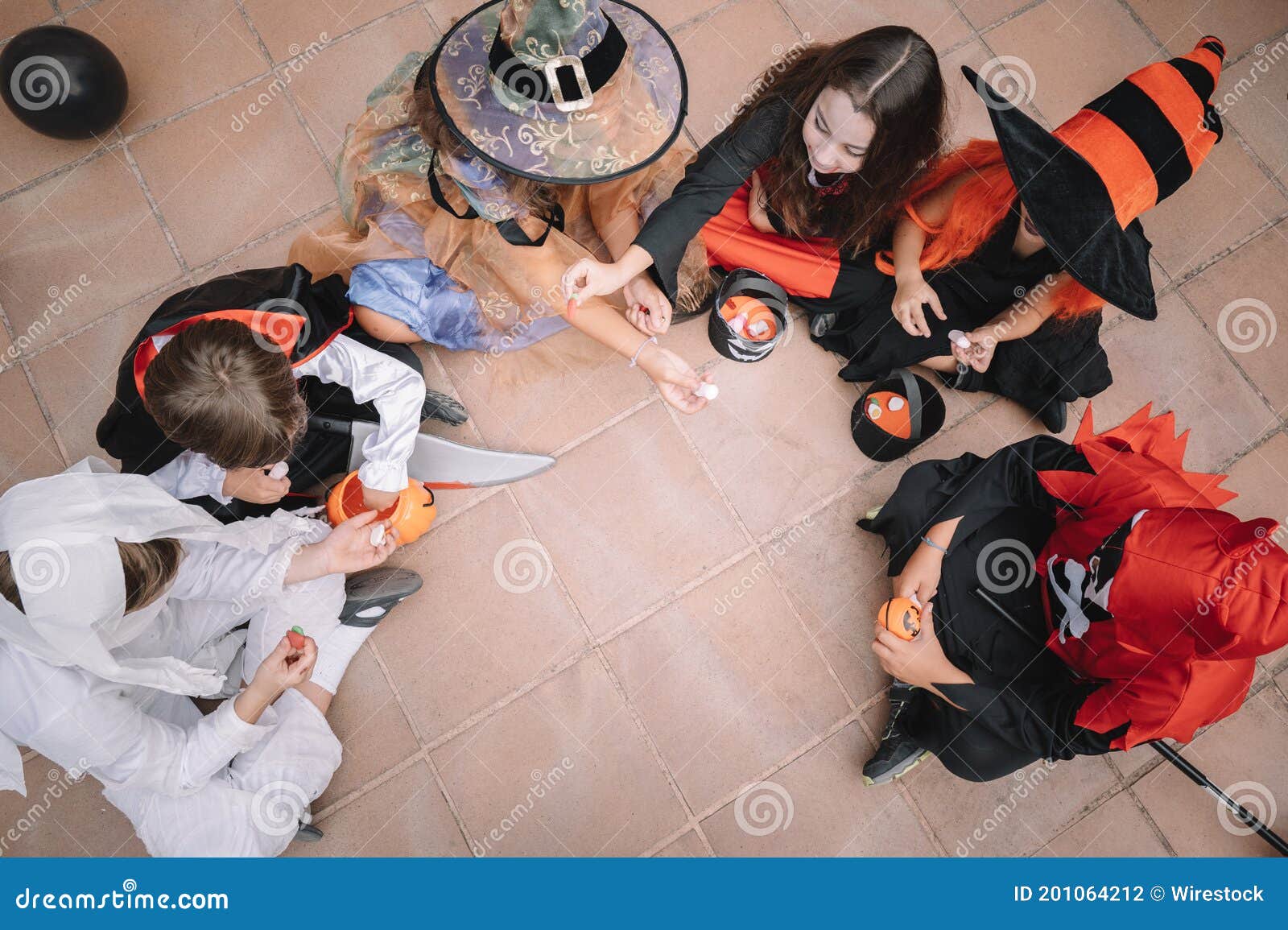 Children Sharing and Comparing Their Candies on Halloween Sitting on a ...