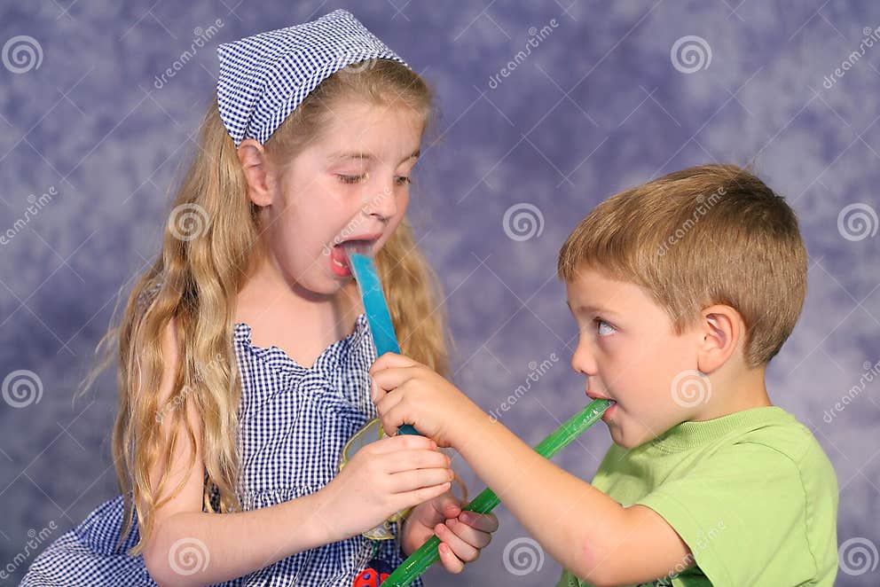 Children sharing popsicles stock photo. Image of love - 2322680