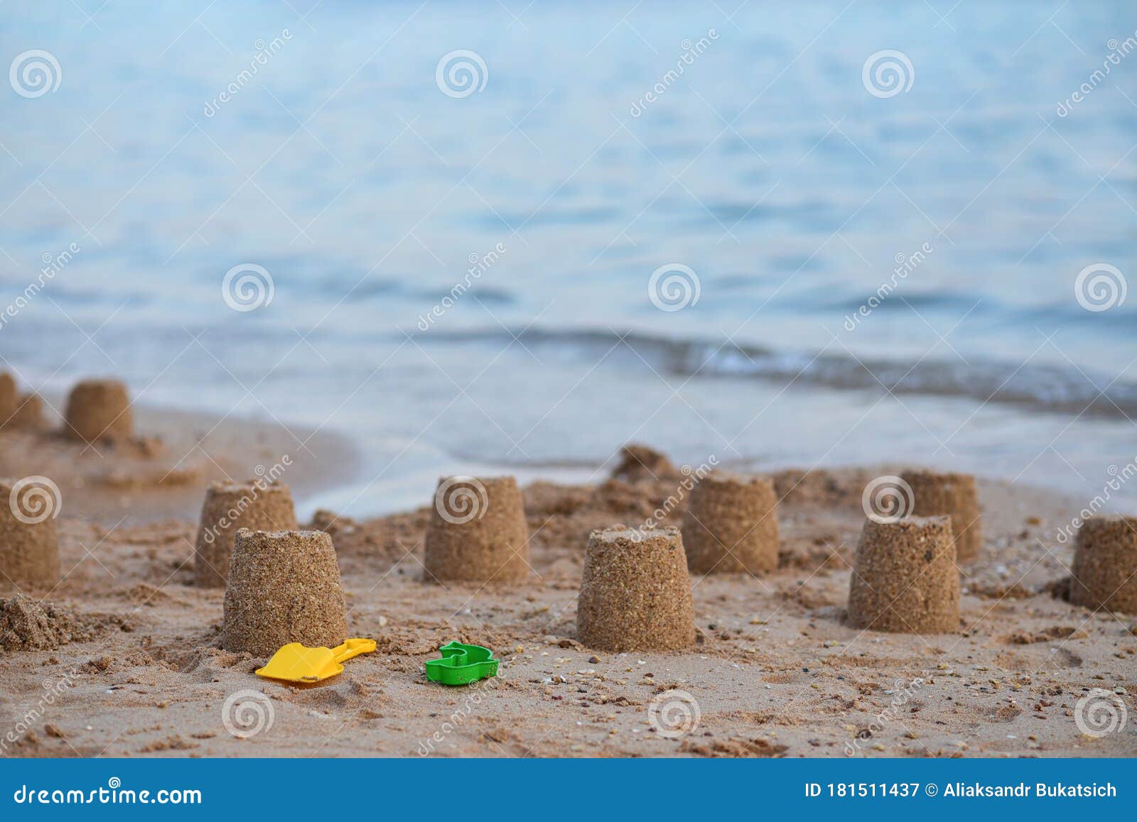 Children Shovel with Sand Figures on a Deserted Beach Stock Image ...