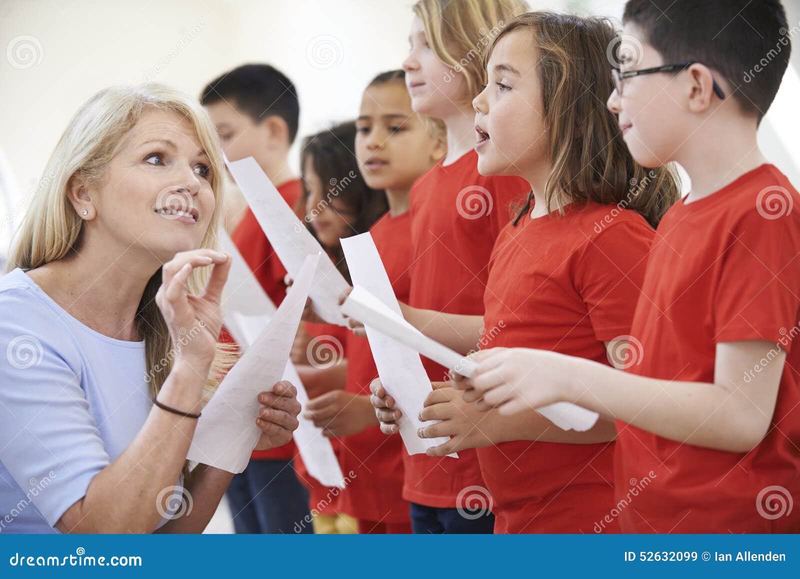 Children in Singing Group Being Encouraged by Teacher Stock Image ...