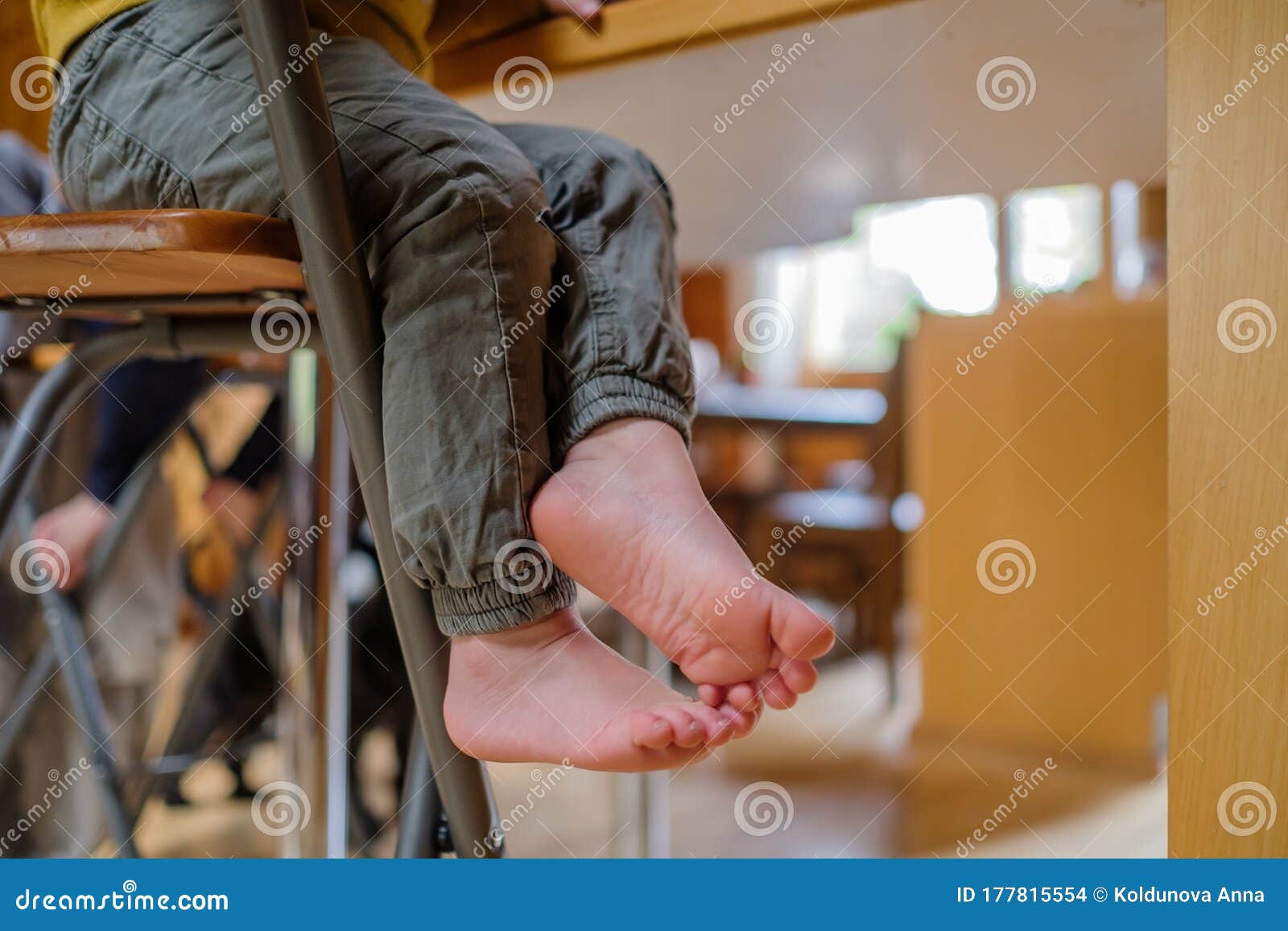 Children Sitting at Table on Kitchen. View on Legs Stock Photo - Image ...