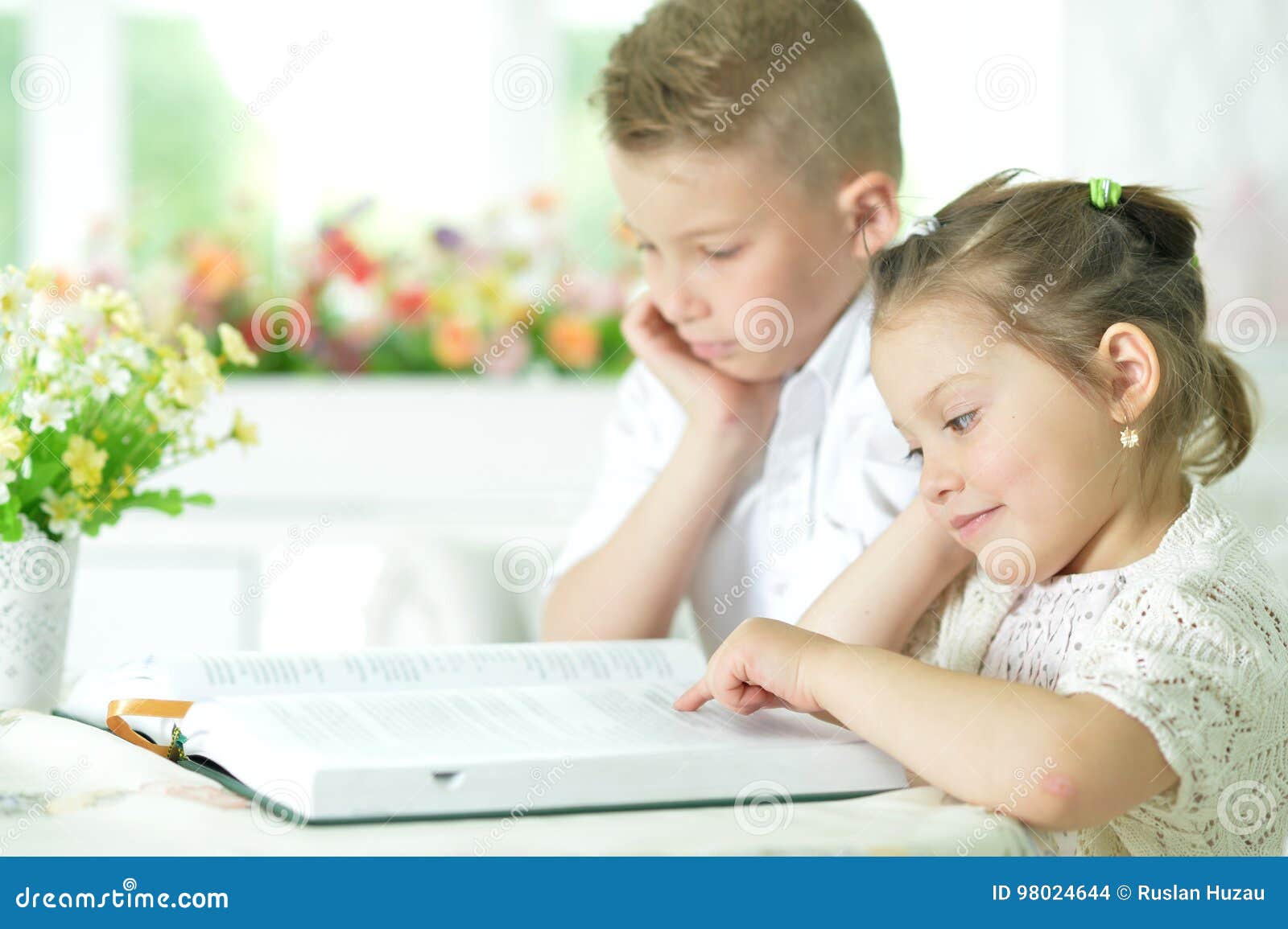 Children Sitting at Table and Reading Stock Photo - Image of emotions ...