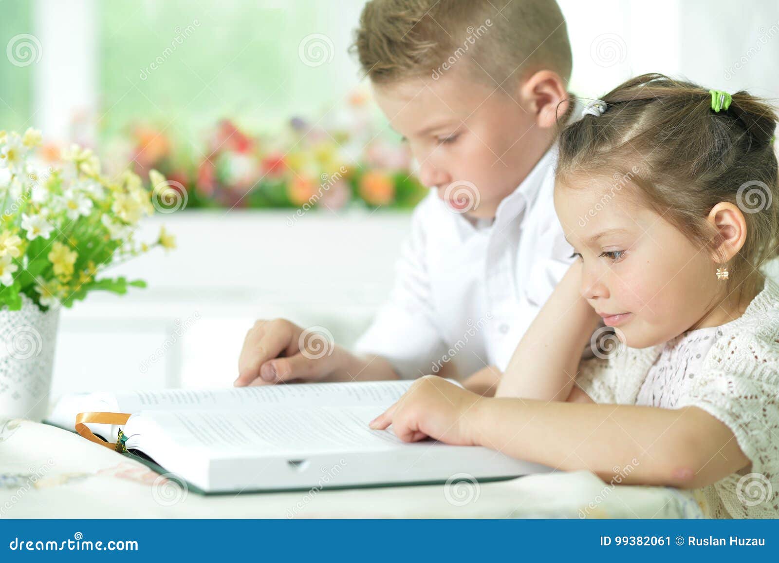 Children Sitting at Table and Reading Stock Image - Image of cute ...
