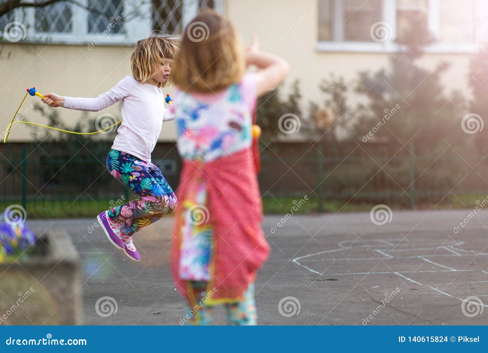Children skipping outdoors stock photo. Image of sisters - 140615824