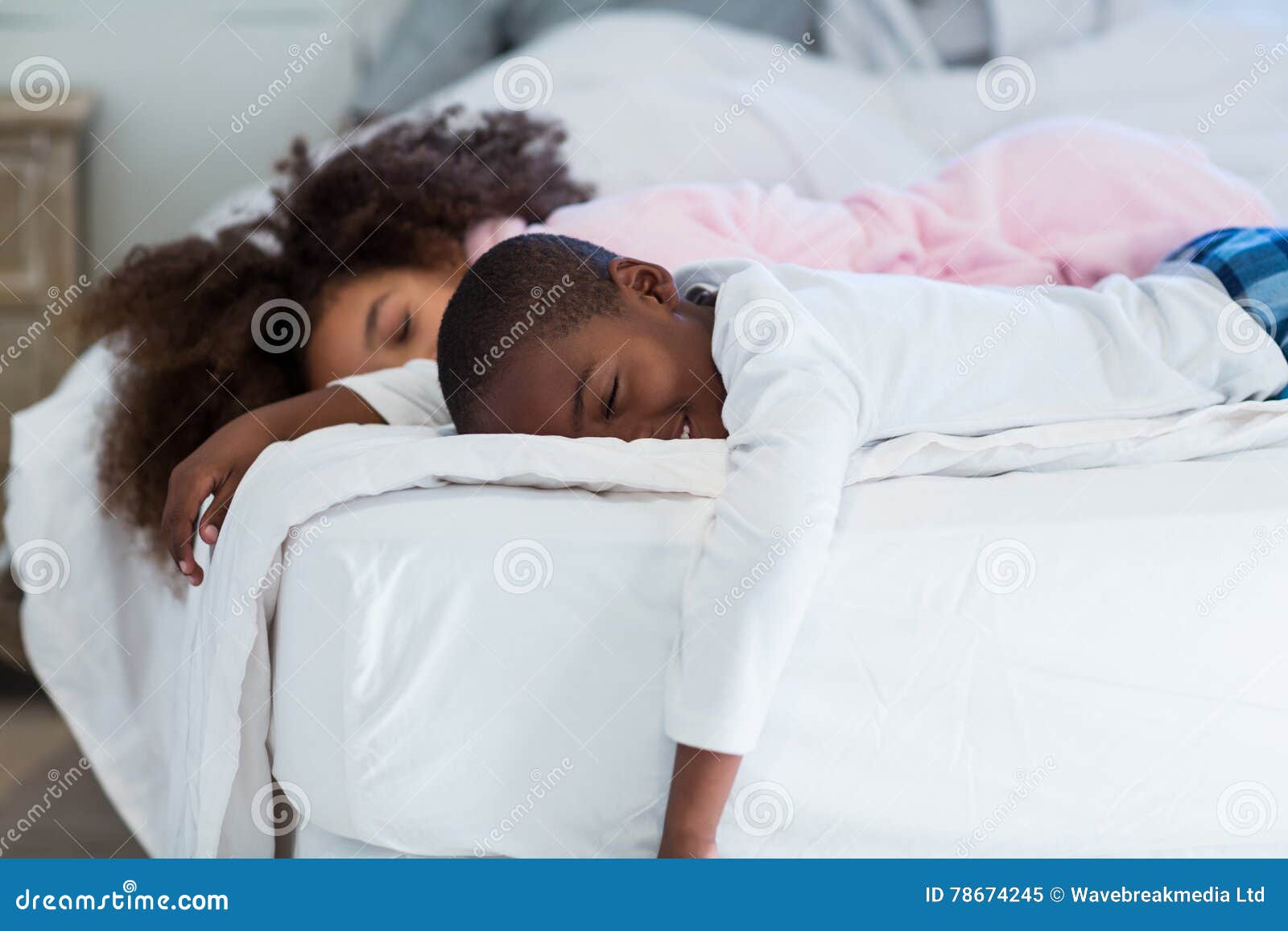 Children sleeping on bed stock image. Image of black - 78674245