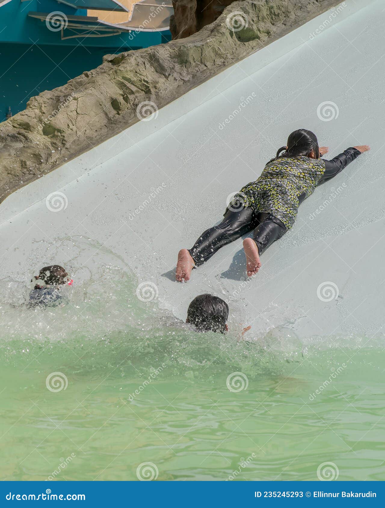 Children Sliding into Pool after Going Down Water Slide during Summer ...